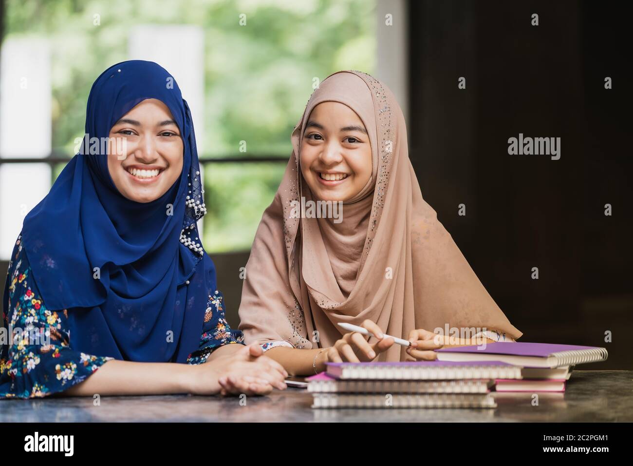 Muslim Student reading book Stock Photo - Alamy