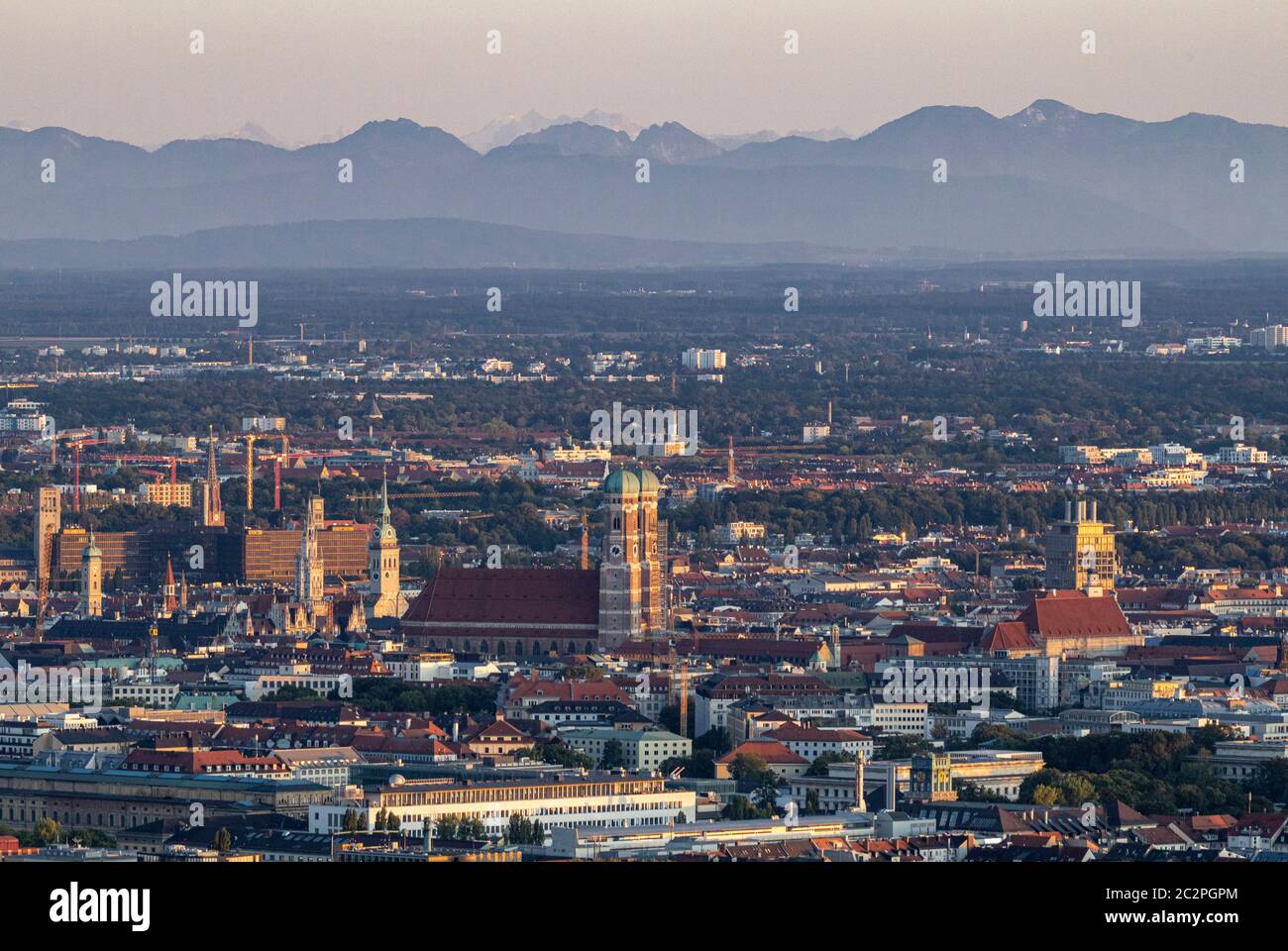 Evening view of downtown Munich in front of the Alps Stock Photo - Alamy