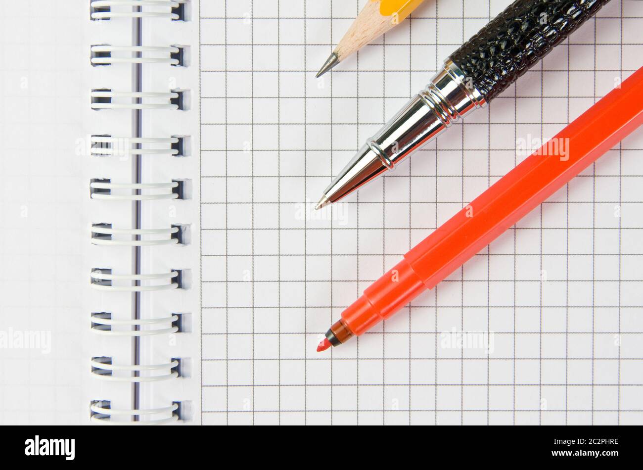 Open writing book with pen, pencil and marker Stock Photo - Alamy