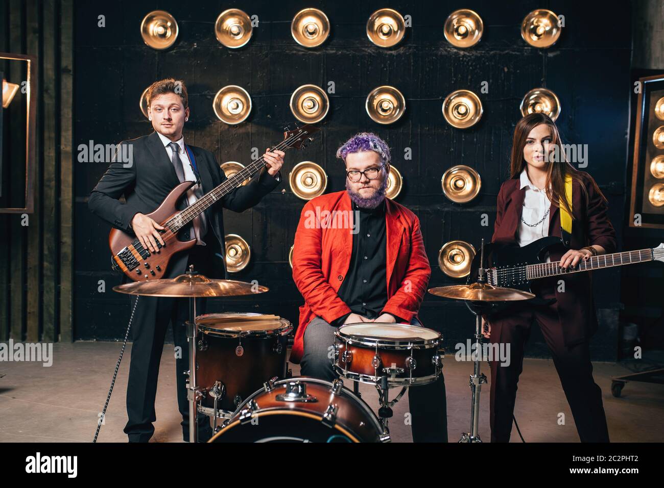 Musical group in suits on the stage with lights, retro style ...