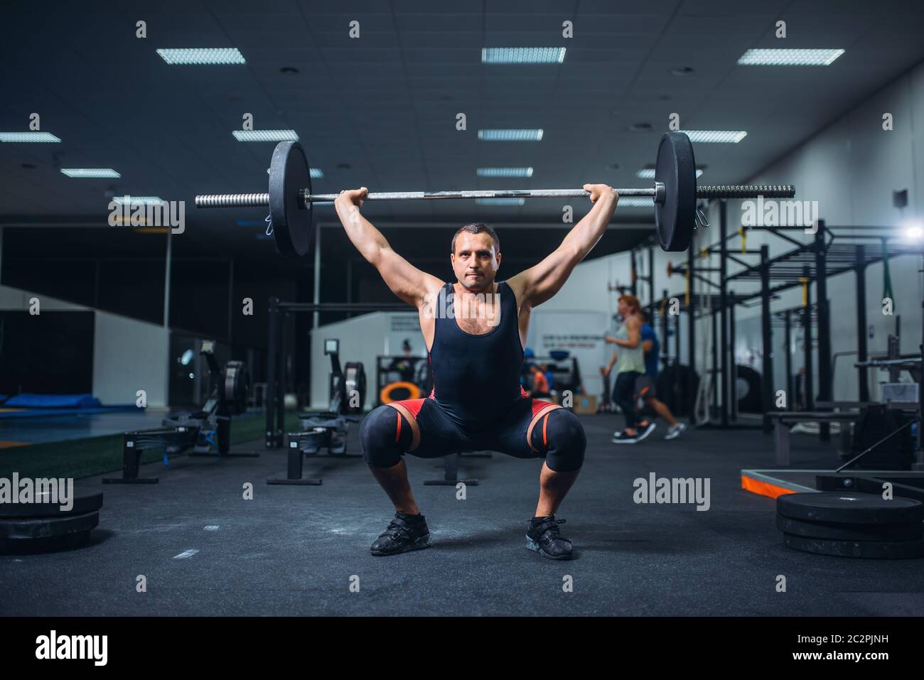 Strong male powerlifter doing deadlift a barbell in gym. Weightlifting ...