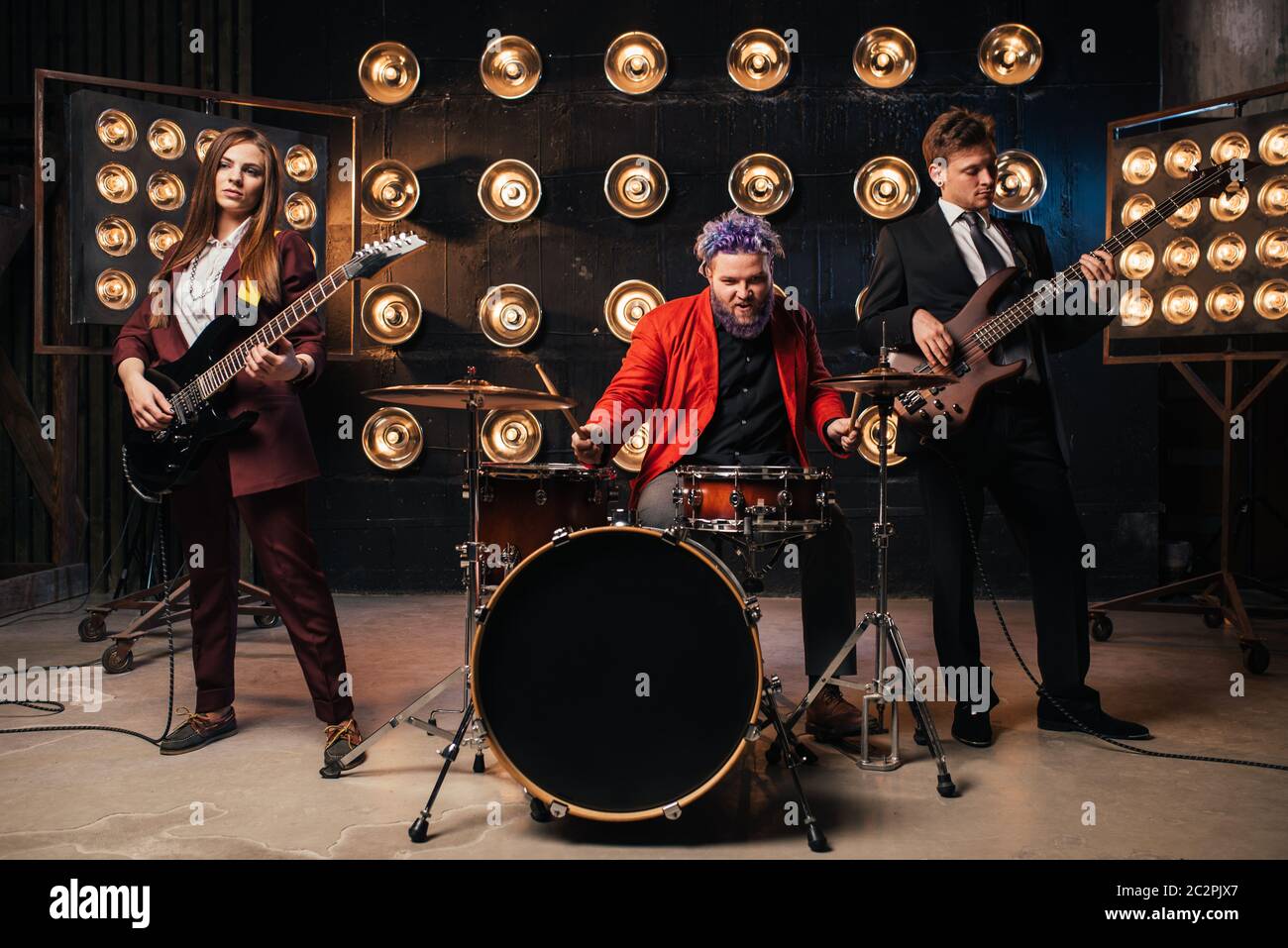 Musicians in suits on the stage with lights, retro style. Guitarists ...