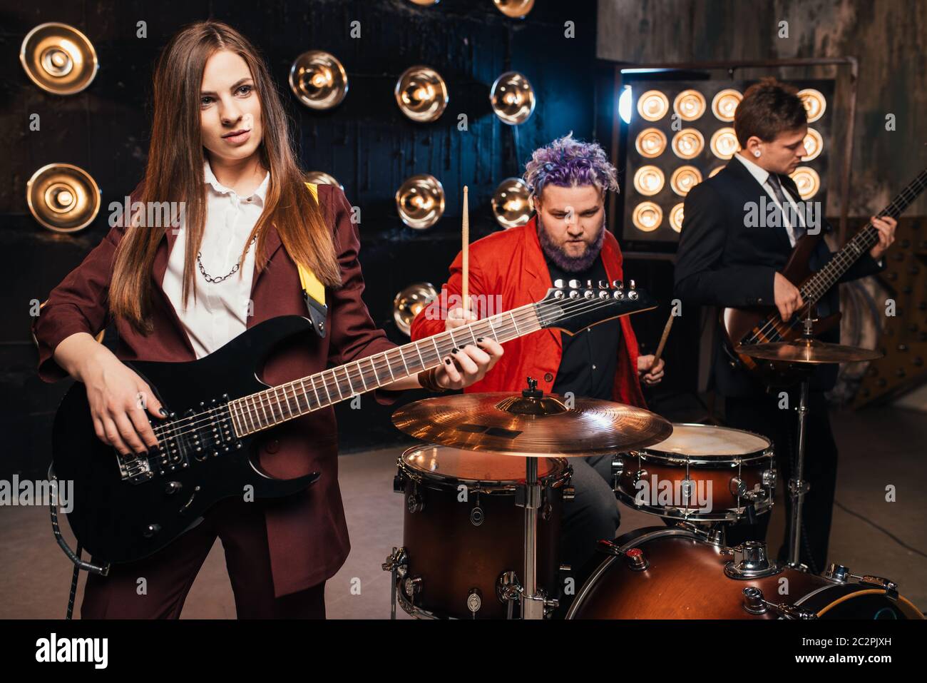 Musicians in suits on the stage with lights, retro style. Guitarists ...