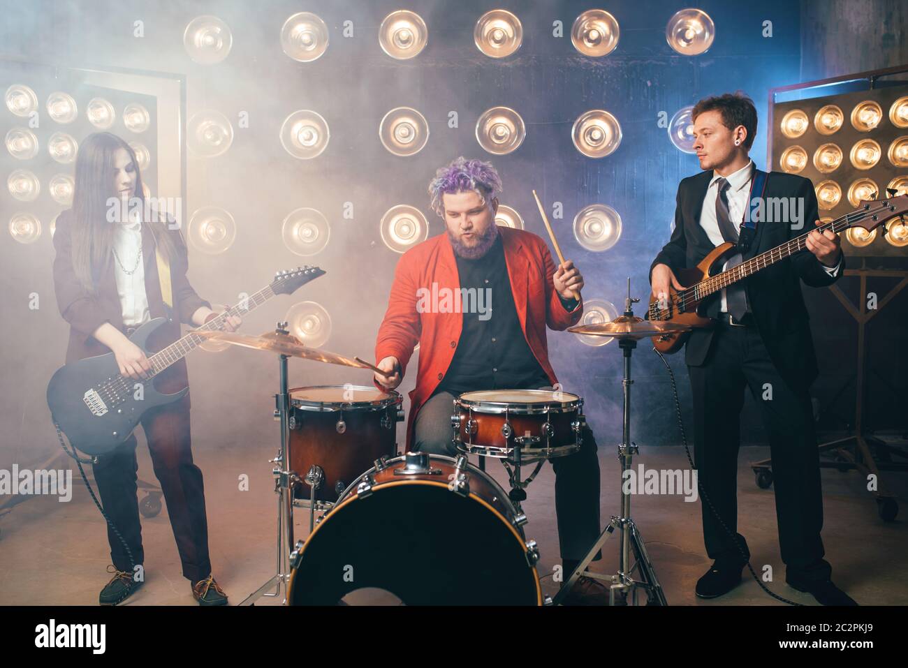 Musicians in suits on the stage with lights, vintage style. Guitarists ...