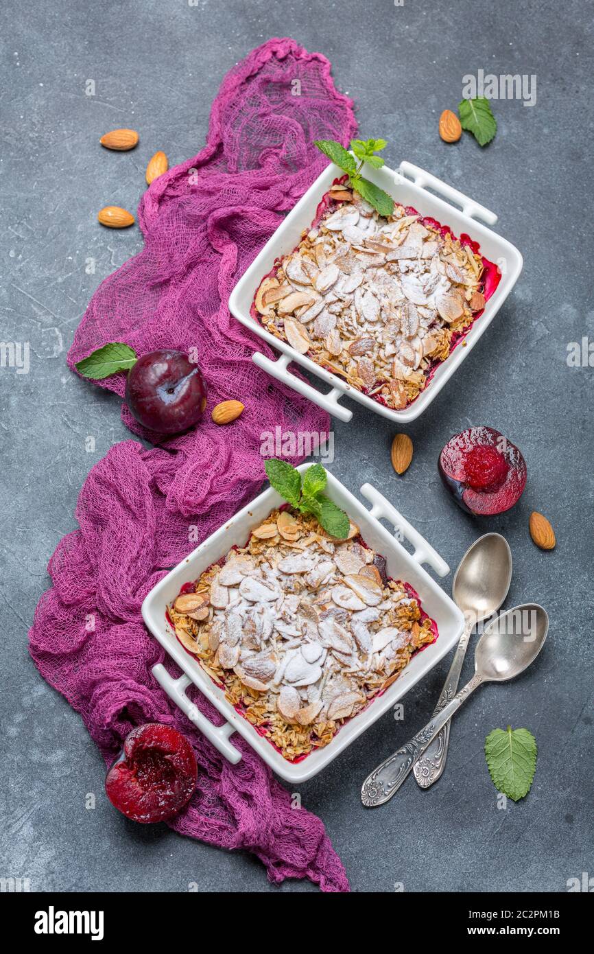 Crumble with red plums and oat flakes Stock Photo - Alamy