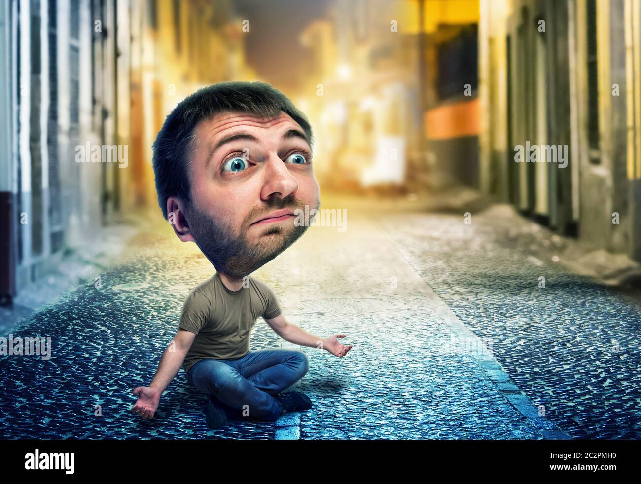 Sad man with a big head sitting in the street in the night Stock Photo ...