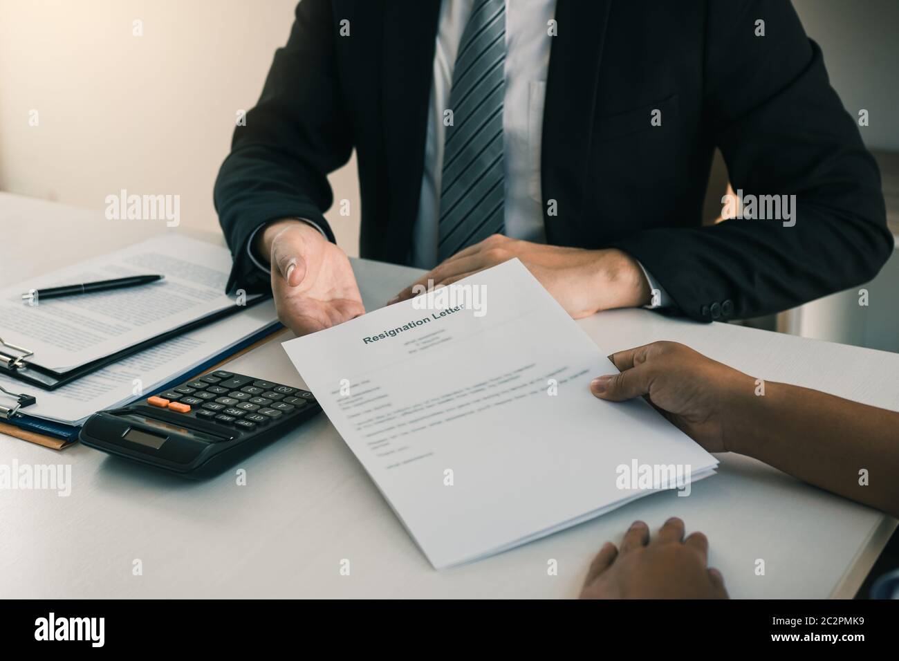 Male employee handed out a resignation envelope to the manager Stock ...