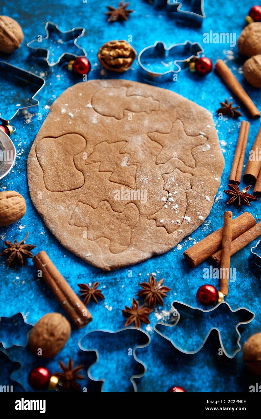 Christmas baking concept. Gingerbread dough with different cutter ...