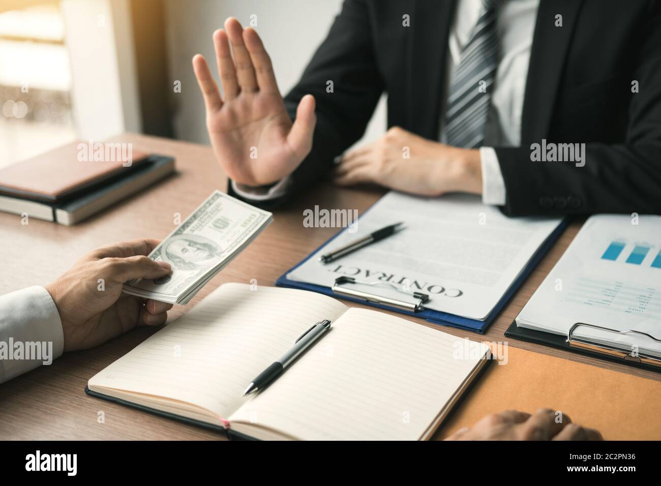 Business person refusing bribe given money by partner with anti bribery ...