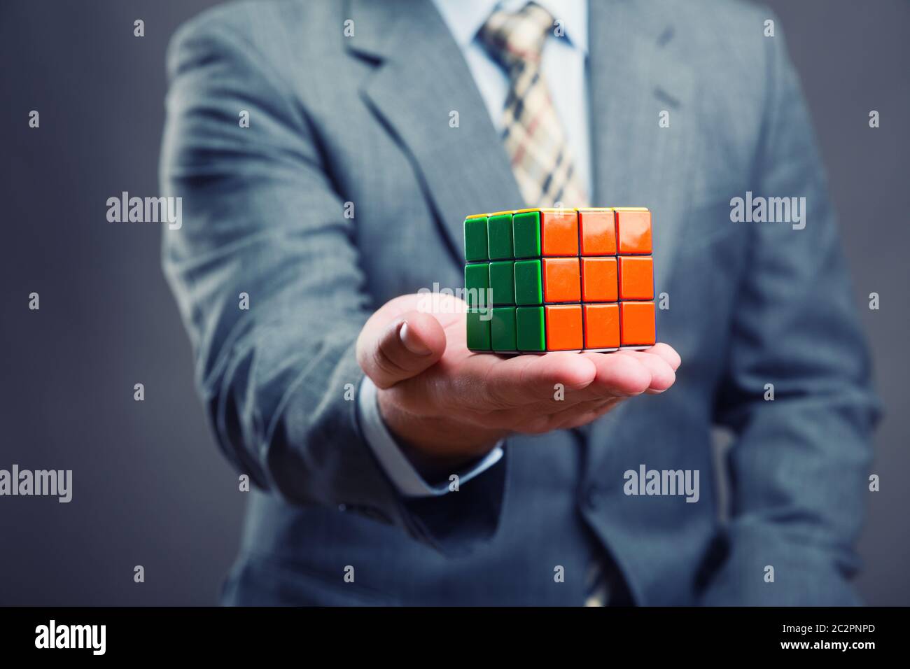 Happy businessman holding rubik cube hi-res stock photography and ...