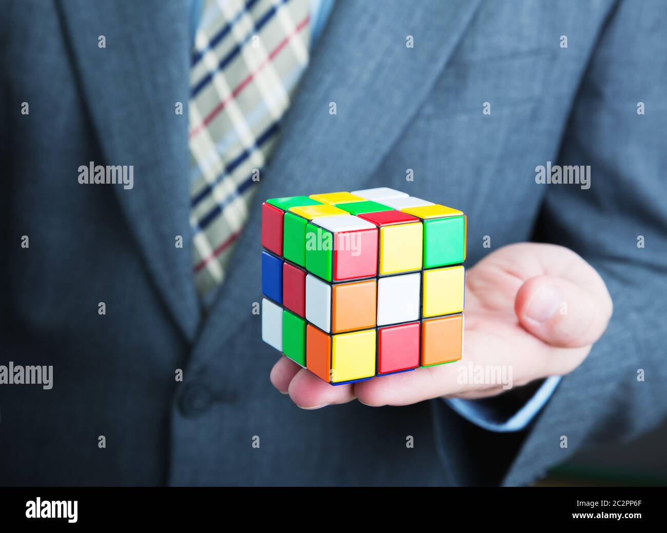 Businessman holding rubik cube closeup picture Stock Photo - Alamy