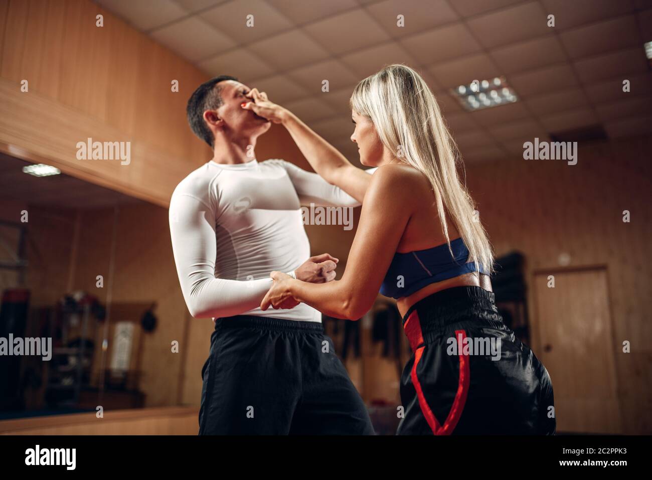 Female person makes pain in the eyes, self-defense workout with male ...