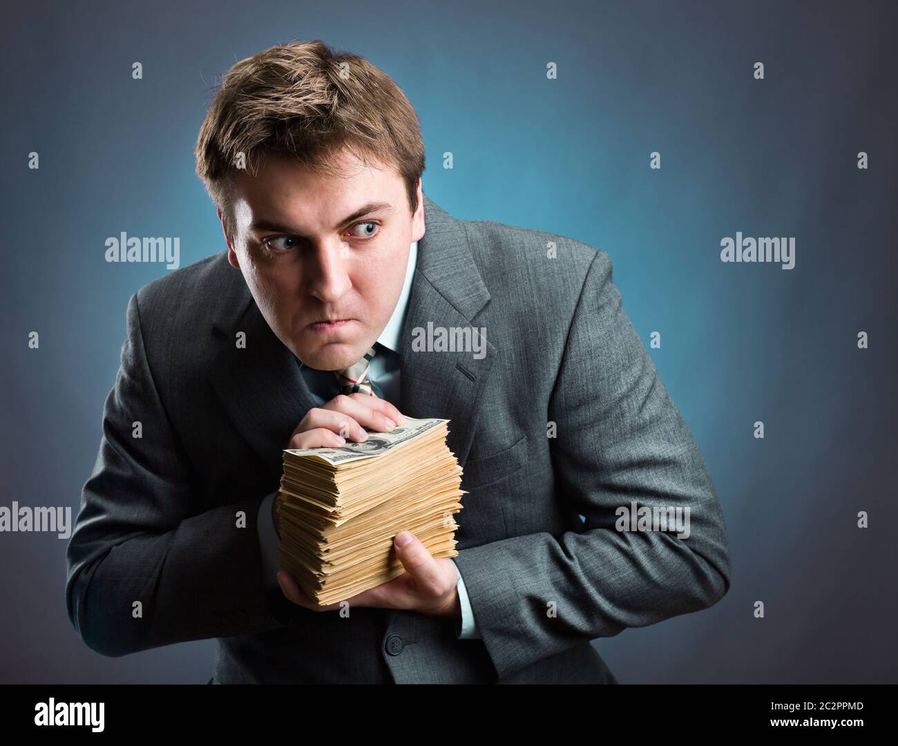 Man holding big pack of money Stock Photo - Alamy