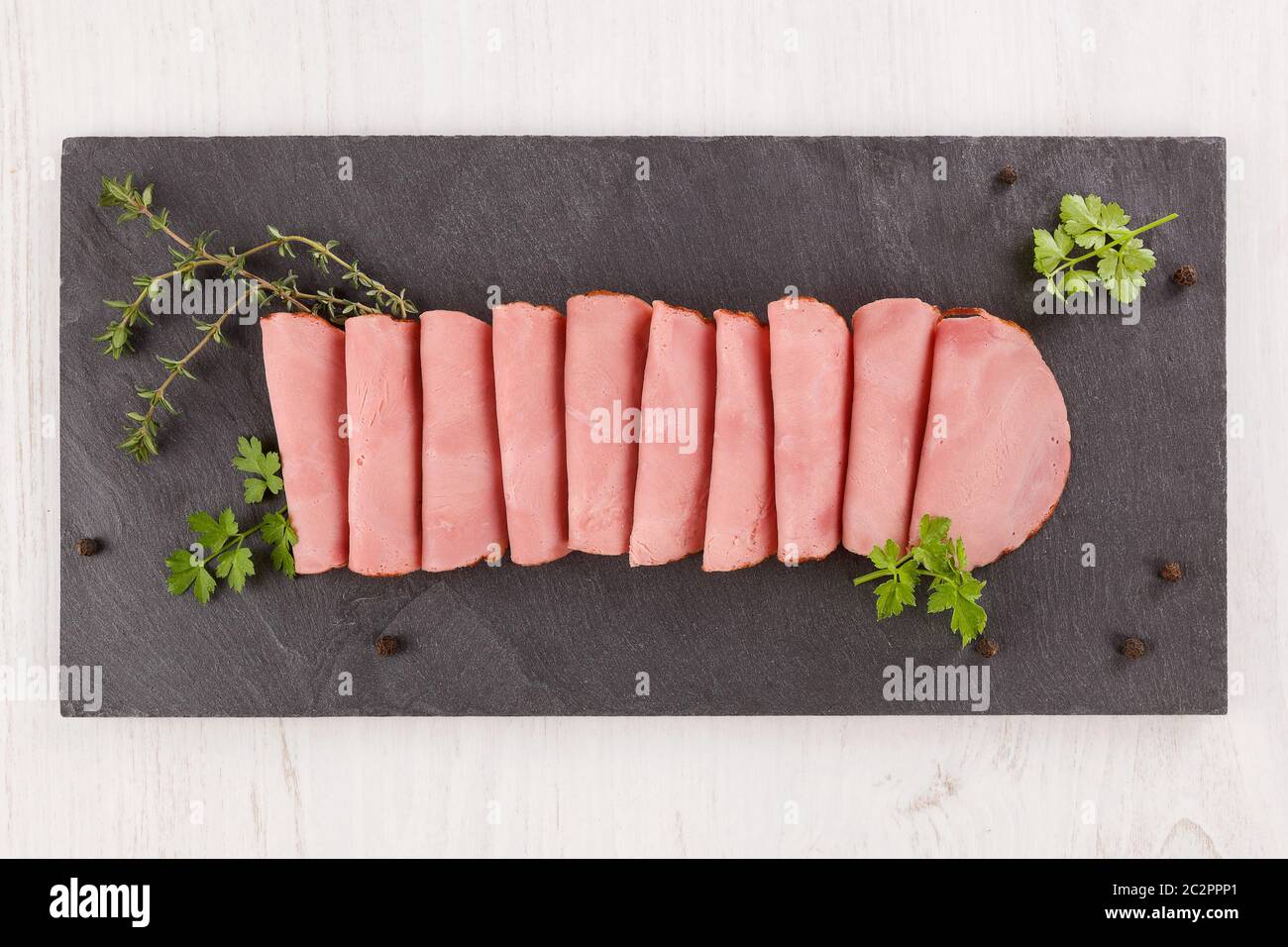 Delicious sliced duck ham served with fresh herbs. Culinary appetizer ...