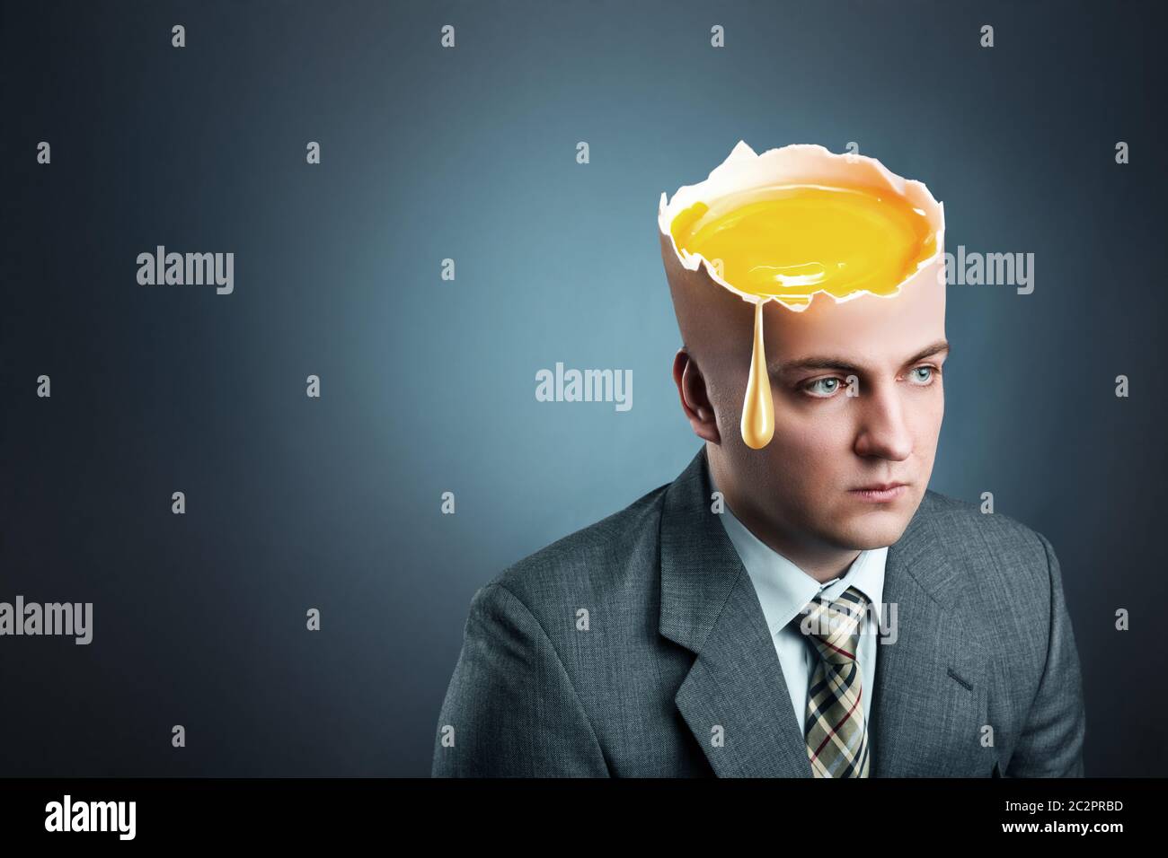 Sad businessman with egg head isolated on gray Stock Photo - Alamy