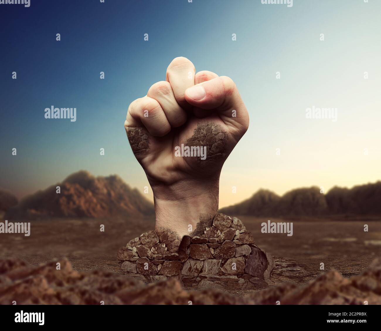 Human fist bursts through the ground over mountains background Stock ...