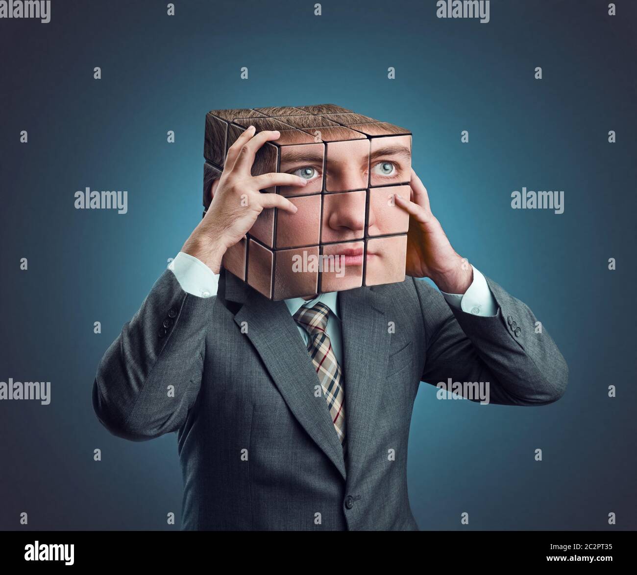 Businessman wearing in suit holding his rubik cube head Stock Photo - Alamy