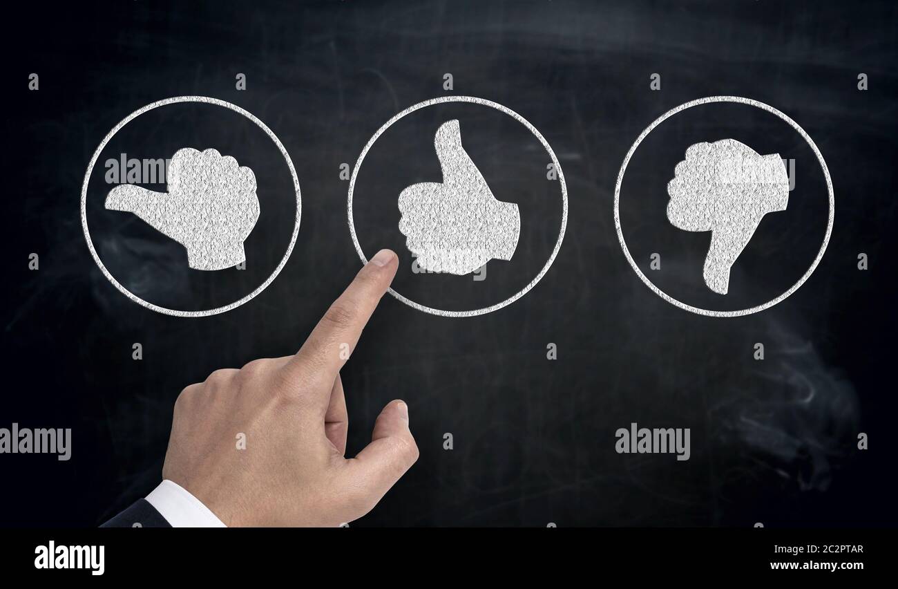 Hand points to thumbs up icons concept Stock Photo - Alamy