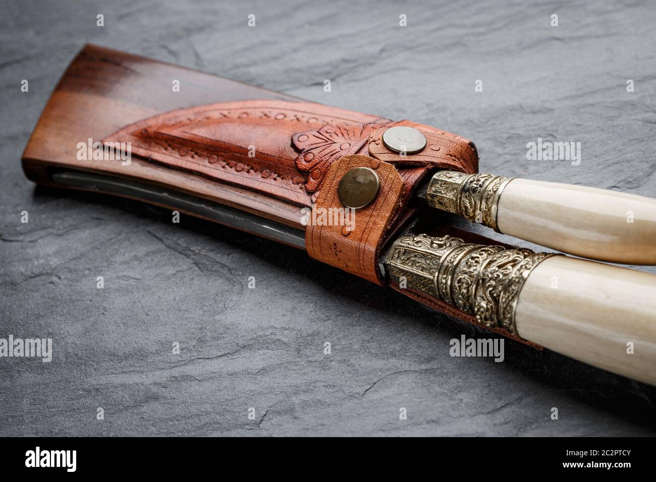 Traditional handmade balinese knife belakas shot on a slate background ...