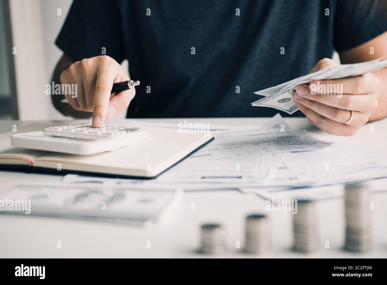 Man use calculators and documents that calculate expenses in the home ...