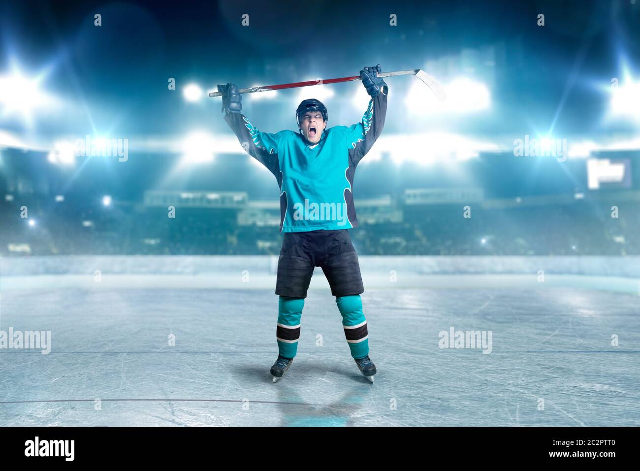 Hockey player raised his hands up, winner threw the puck into the goal ...
