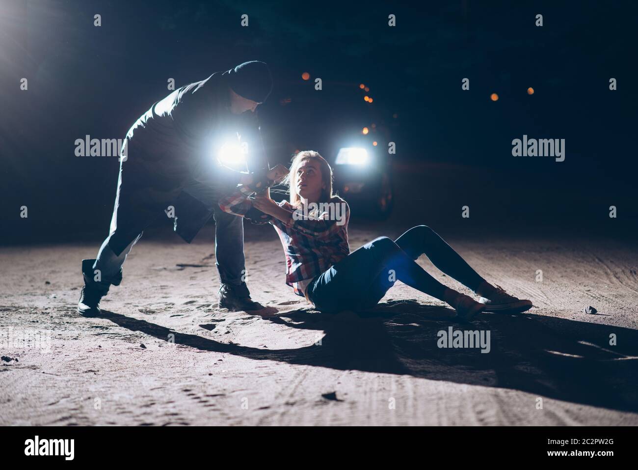 Serial maniac in leather coat and gloves looks in face of female victim ...