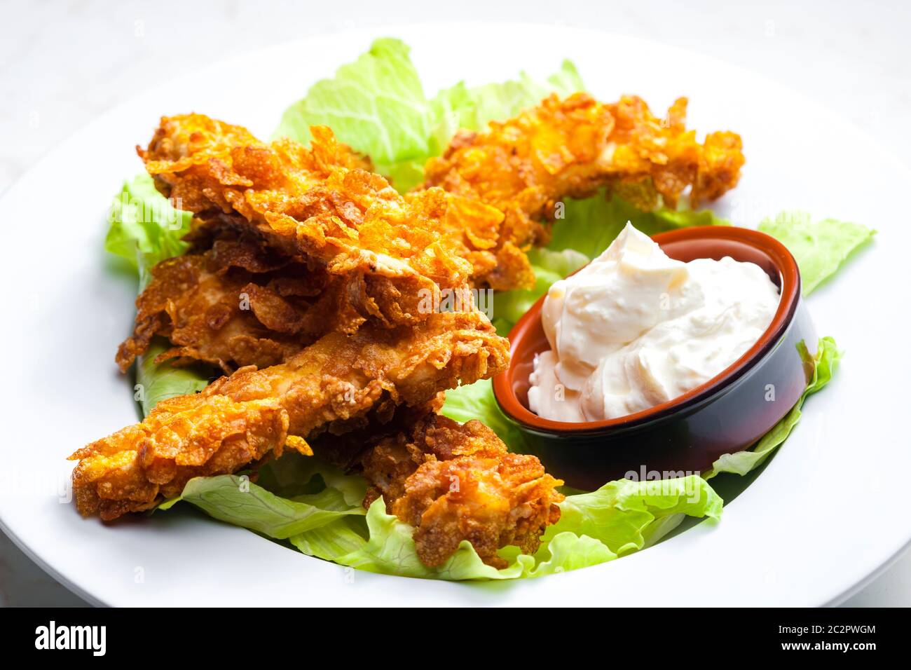 homemade chicken strips with garlic dip Stock Photo - Alamy
