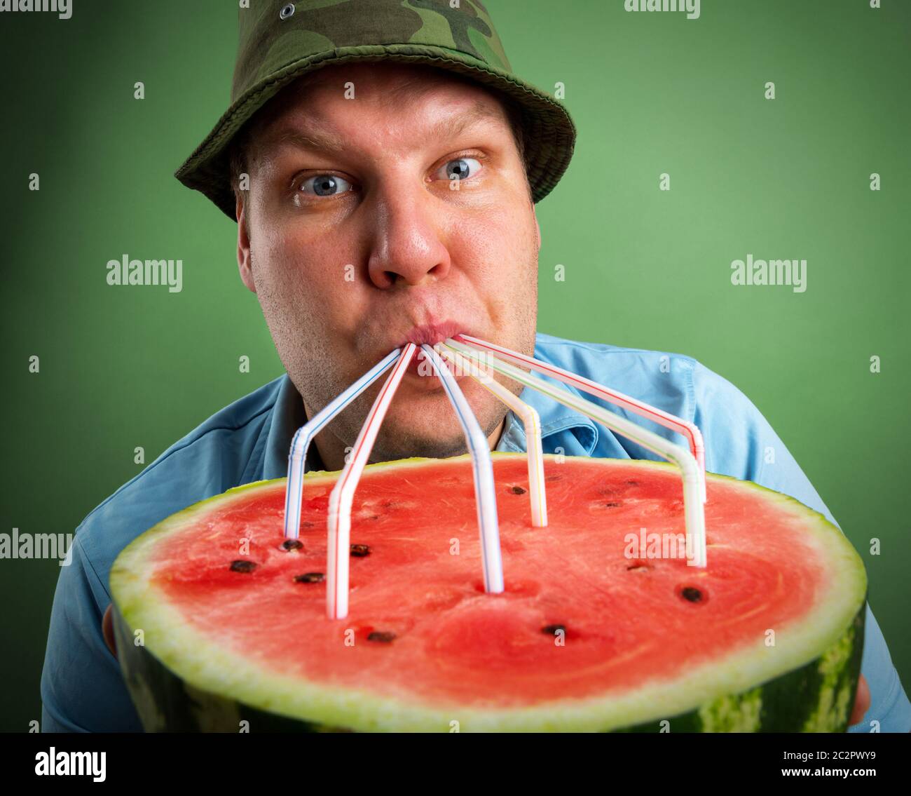 Bizarre farmer drinking watermelon juice through a tubules Stock Photo ...