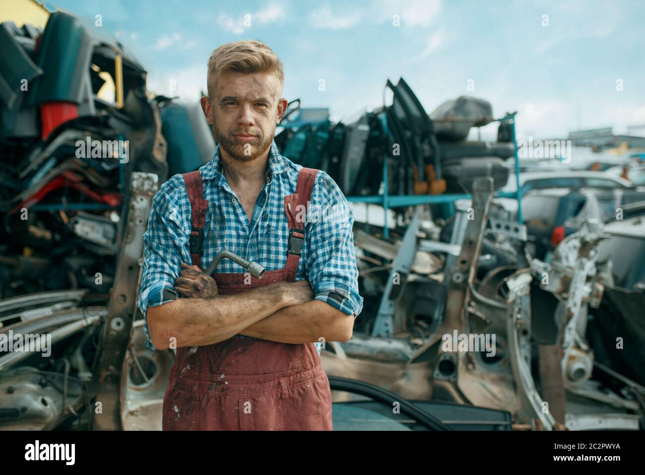Dirty male repairman on car junkyard. Auto scrap, vehicle junk ...