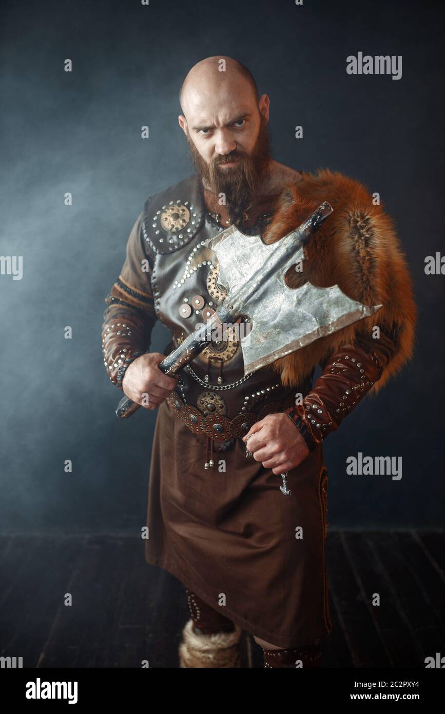 Bearded viking with axe enters the battle, barbarian image. Ancient ...