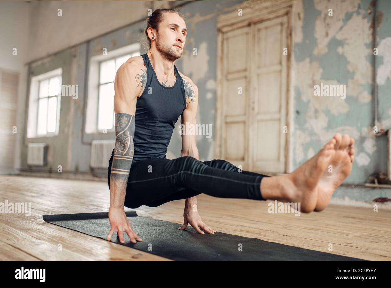 Male yoga standing on hands, balance and press training. Fitness ...