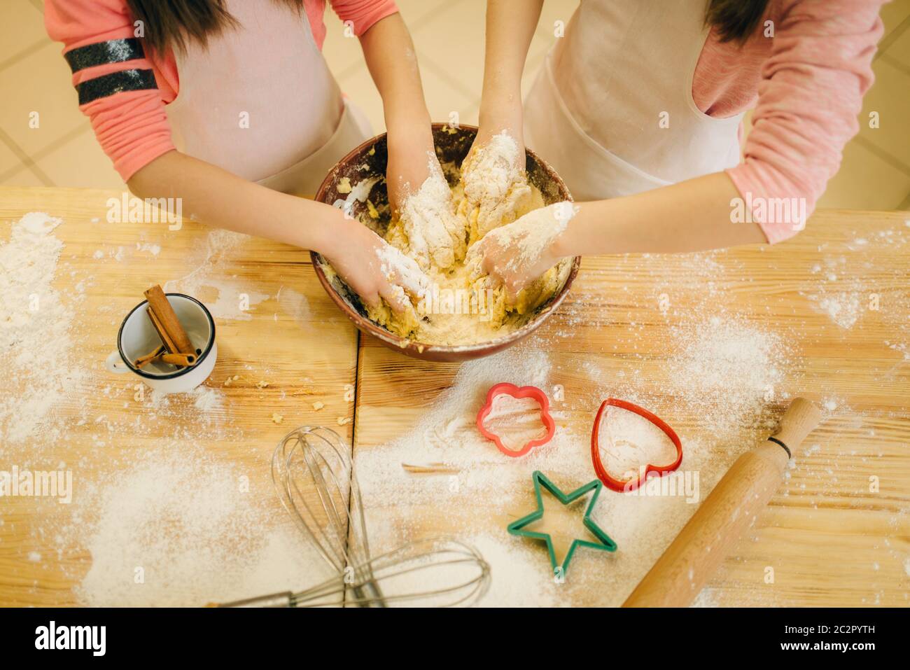 Two little girls chefs crumple the dough, cookies preparation on the ...