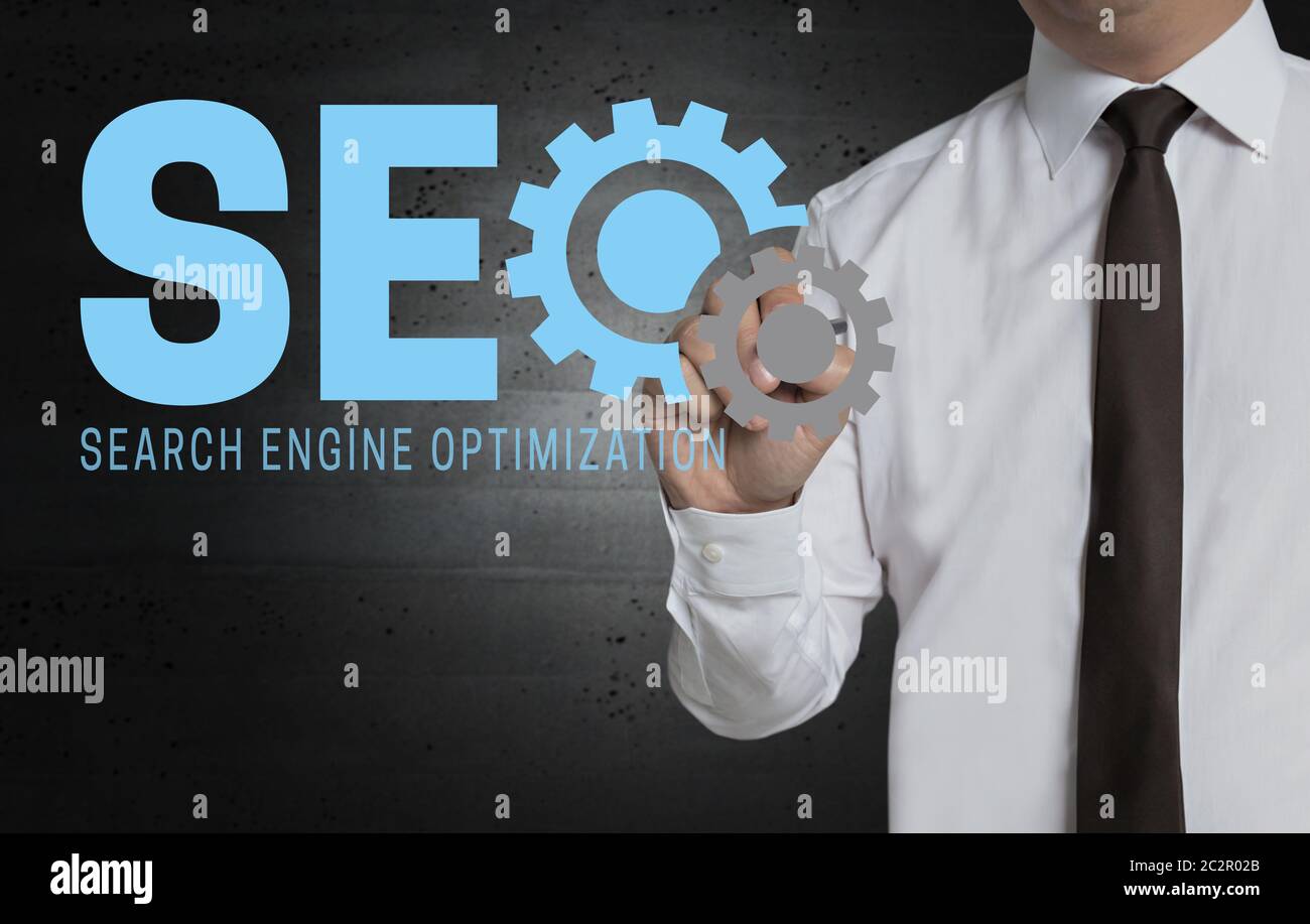 SEO is written by businessman on screen Stock Photo - Alamy