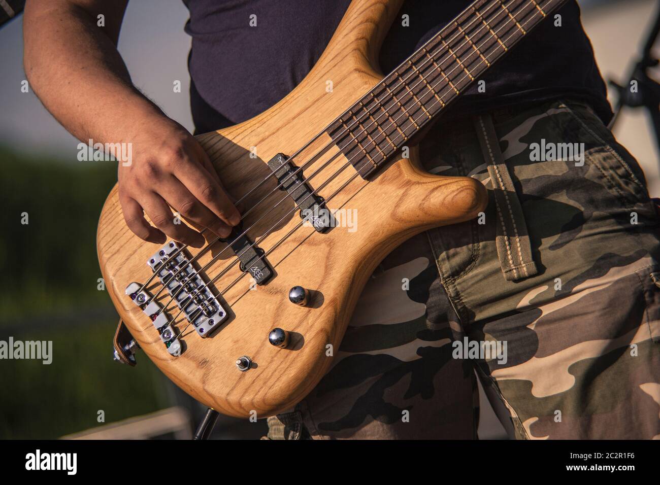 Hand detail while playing a wooden acoustic bass at a rock concert ...