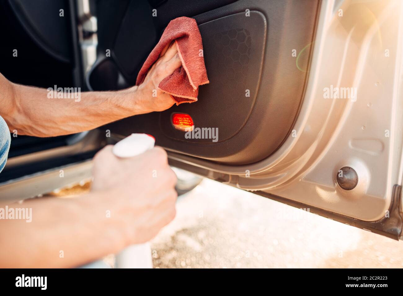 Male hands cleans auto on carwash station. Man rubbing vehicle inside ...