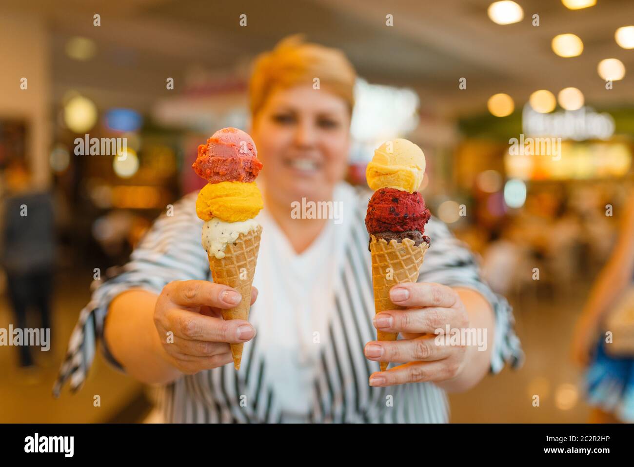 Fat woman holding ice cream in fastfood mall restaurant, unhealthy food ...