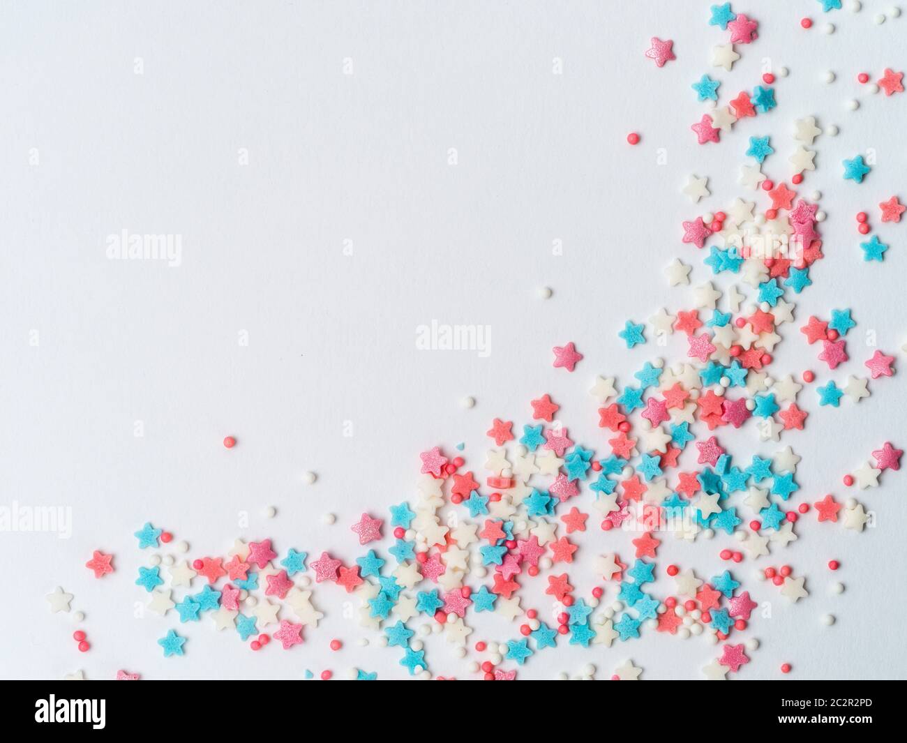 Festive border frame of colorful pastel sprinkles on white background ...