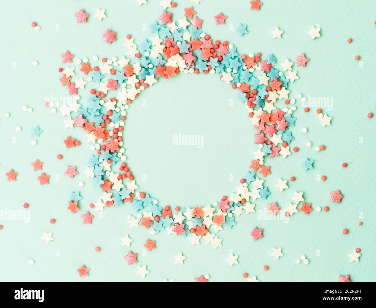 Festive border frame of colorful pastel sprinkles on blue background ...