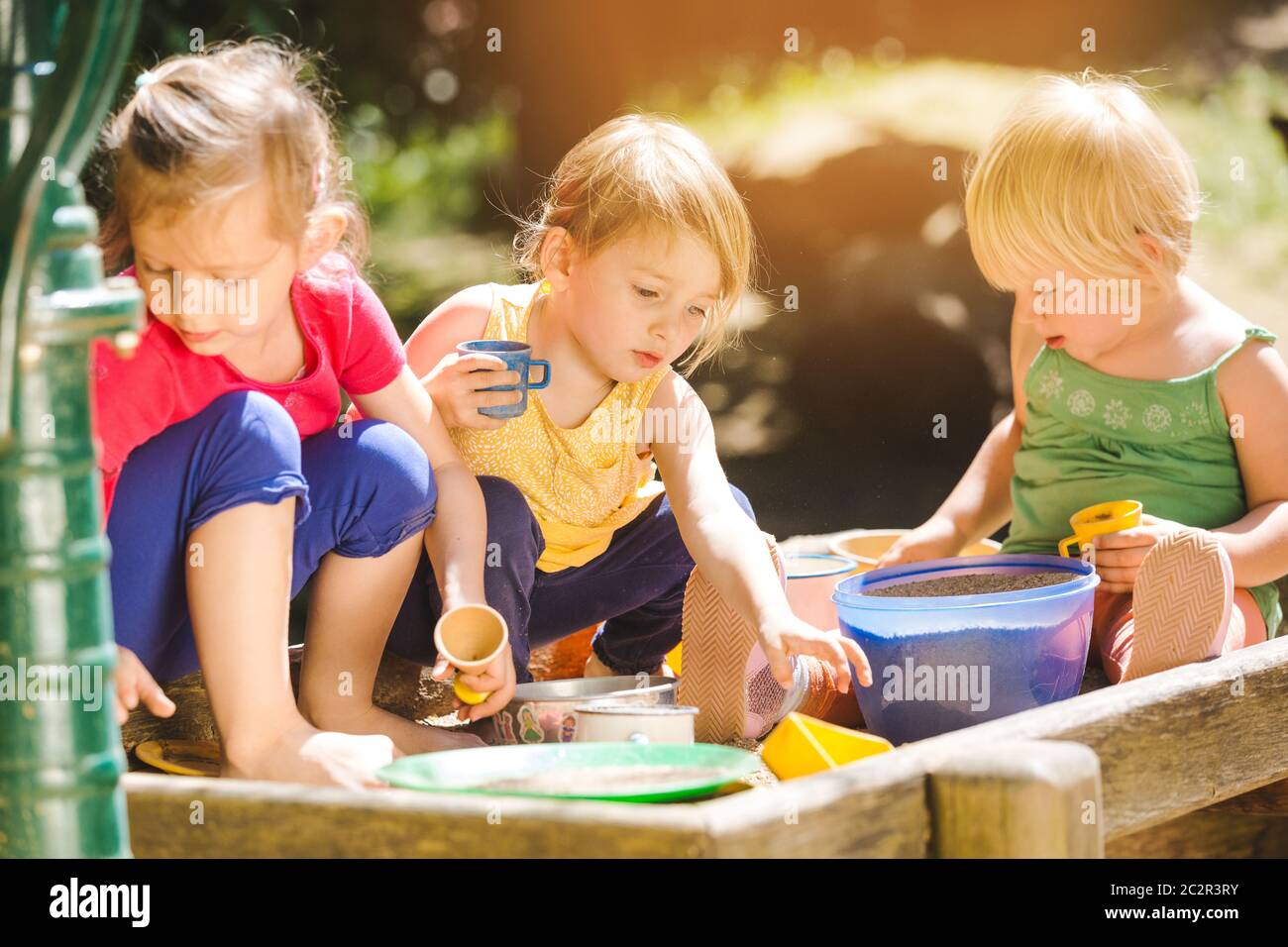 Group of girl children playing in the sandbox with all their toys Stock ...