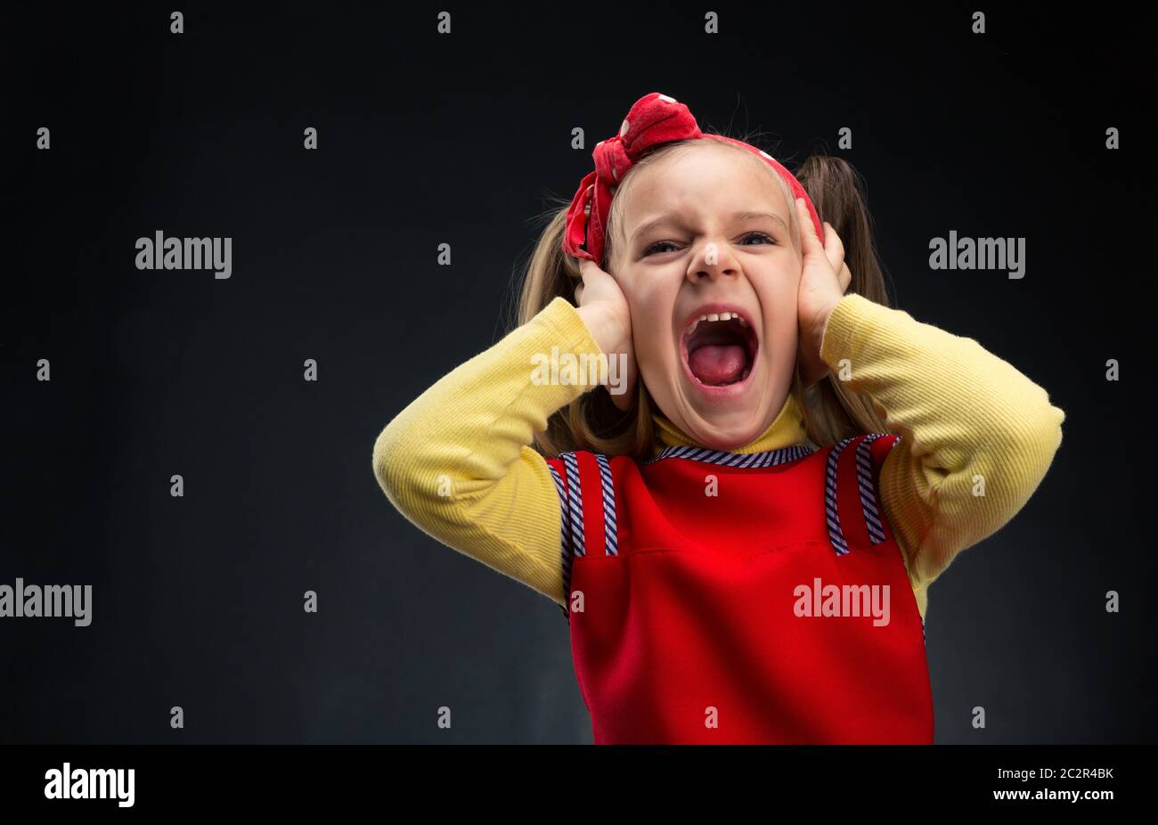 Little girl is screaming with her ears covered by hands Stock Photo - Alamy