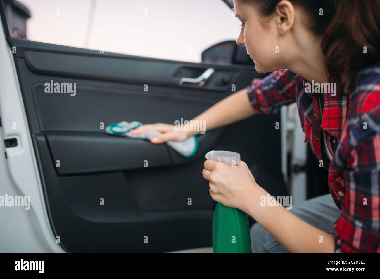 Wet cleaning of the interior of the car on carwash. Lady on self ...