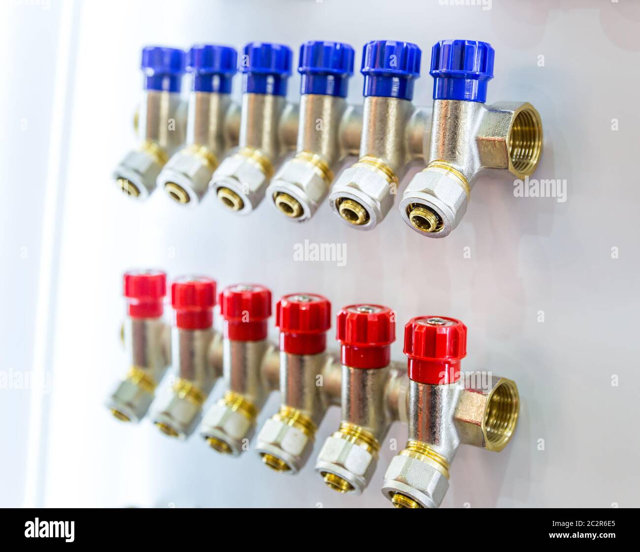 Red and blue valves closeup, new pressure controllers. Plumbing ...