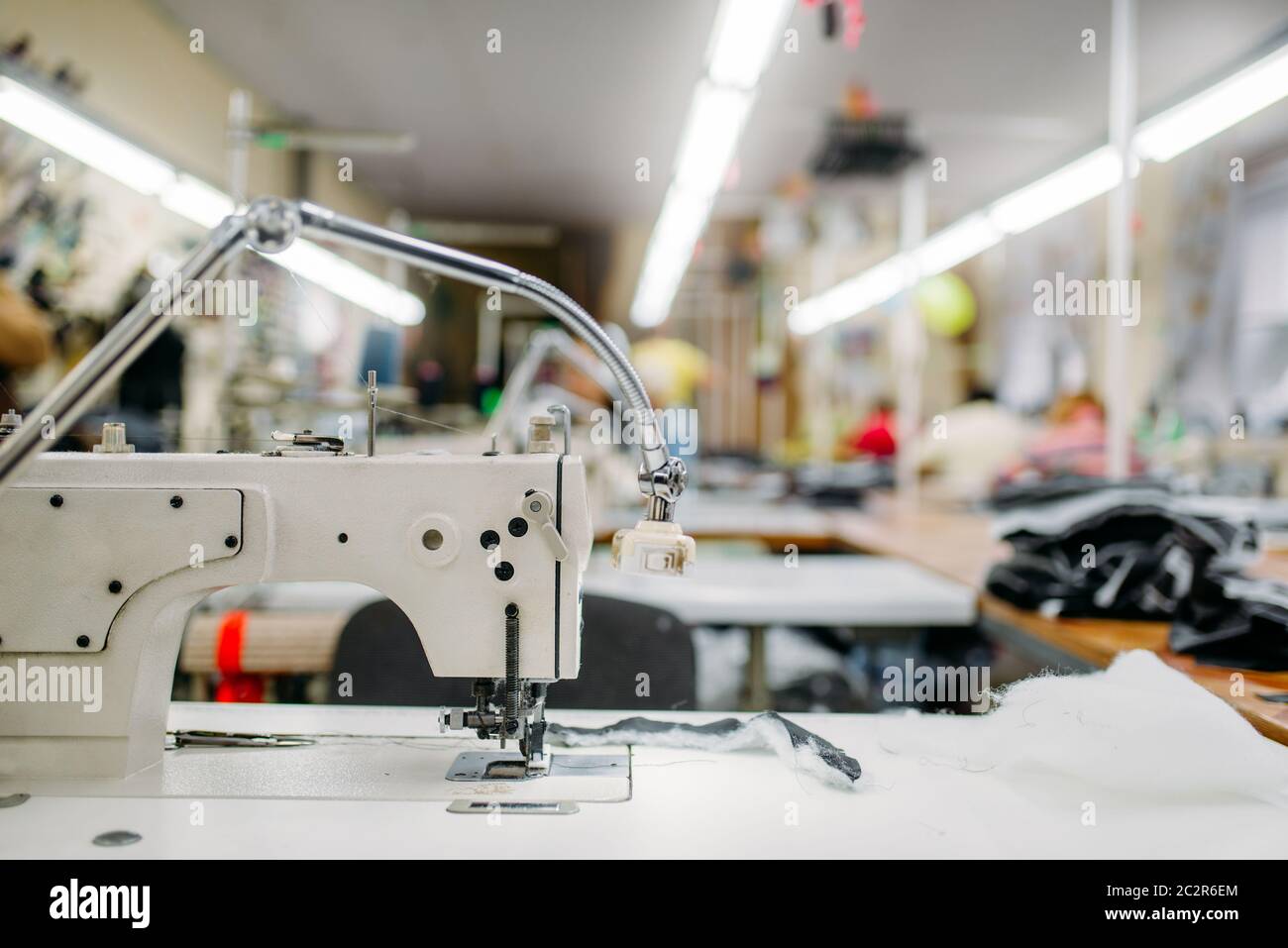 Sewing machine on clothing fabric, nobody. Dressmaking industry ...