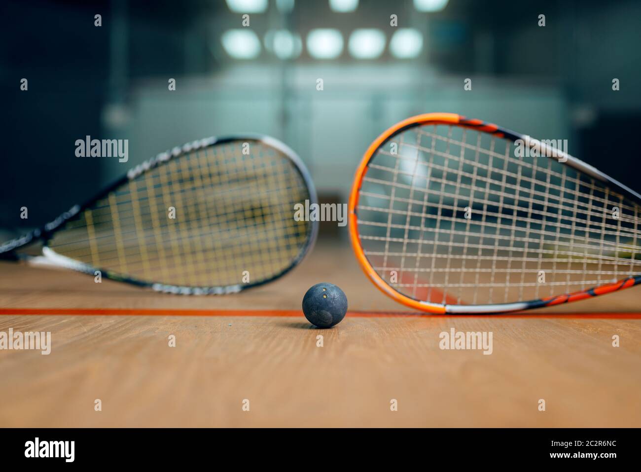 Two squash rackets and ball on court floor, nobody, game concept ...
