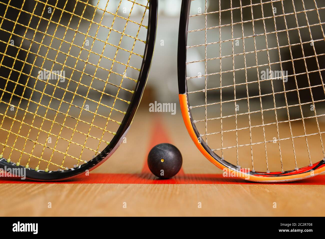 Two squash rackets and ball on court floor, nobody, game concept ...