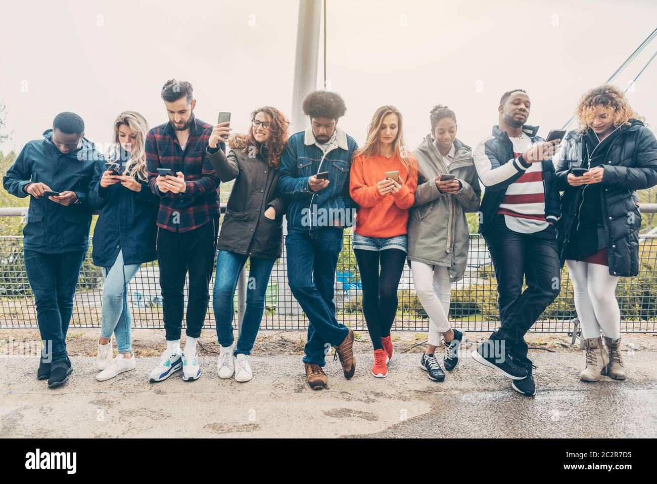Group of young people staring on their phones avoiding other forms of ...
