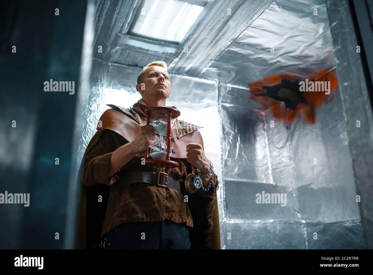 Space traveler looks out of the teleport with foil walls. Fantasy ...