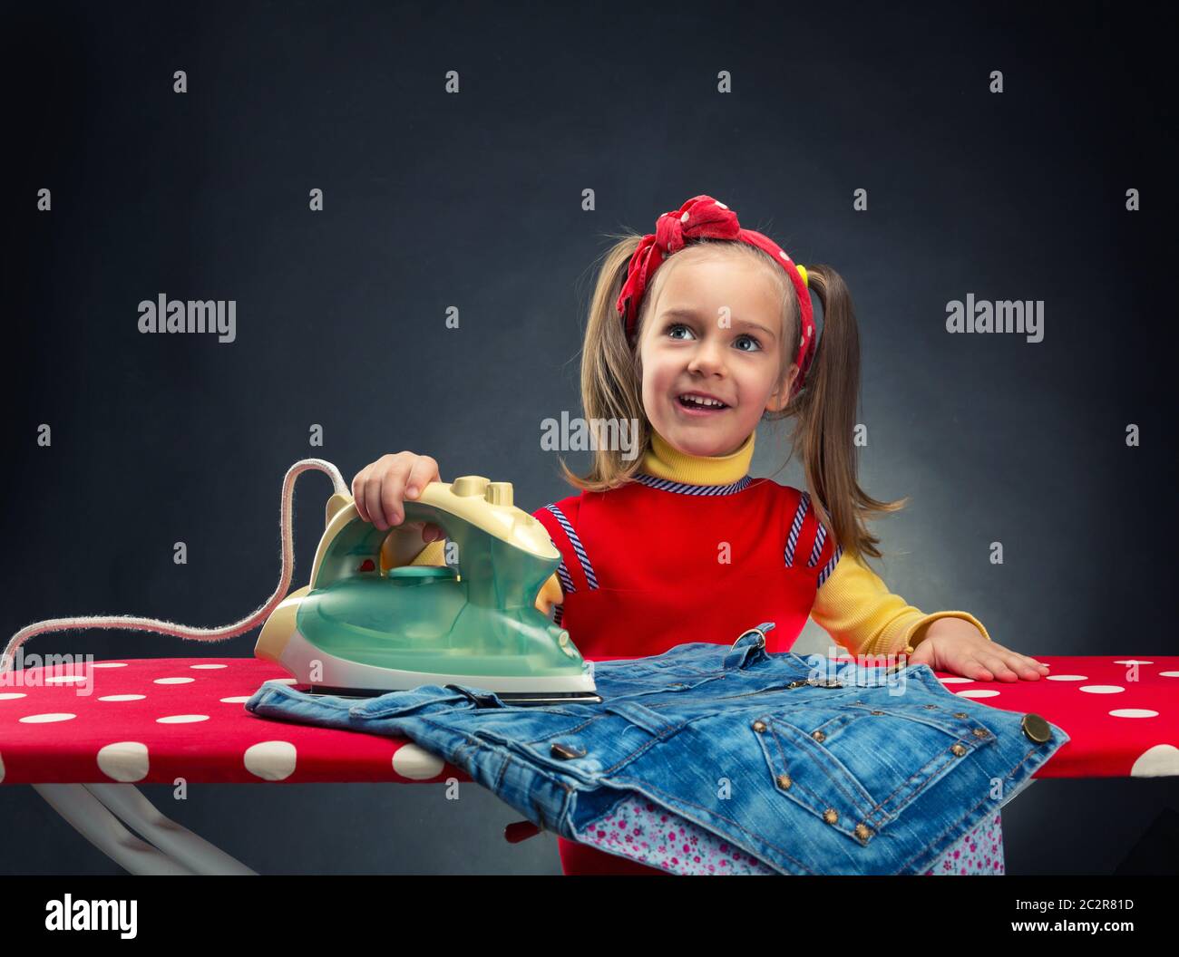 Happy little girl ironing at home Stock Photo - Alamy