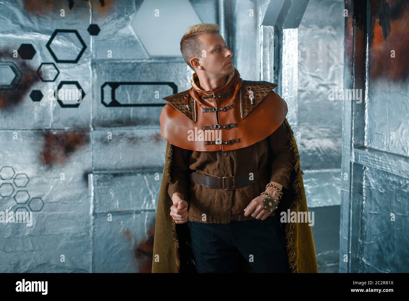 Space traveler looks out of the teleport with foil walls. Fantasy ...