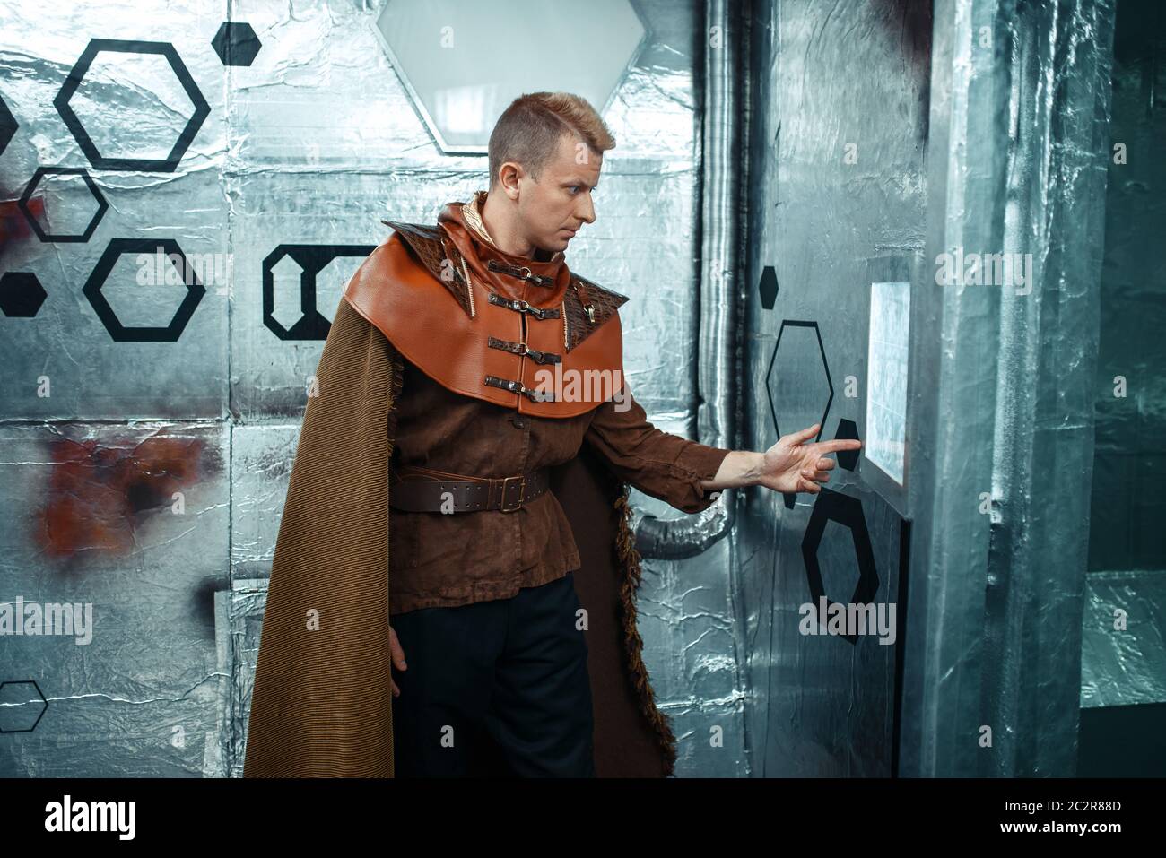 Space traveler enter data on the teleport board, spacecraft with foil ...